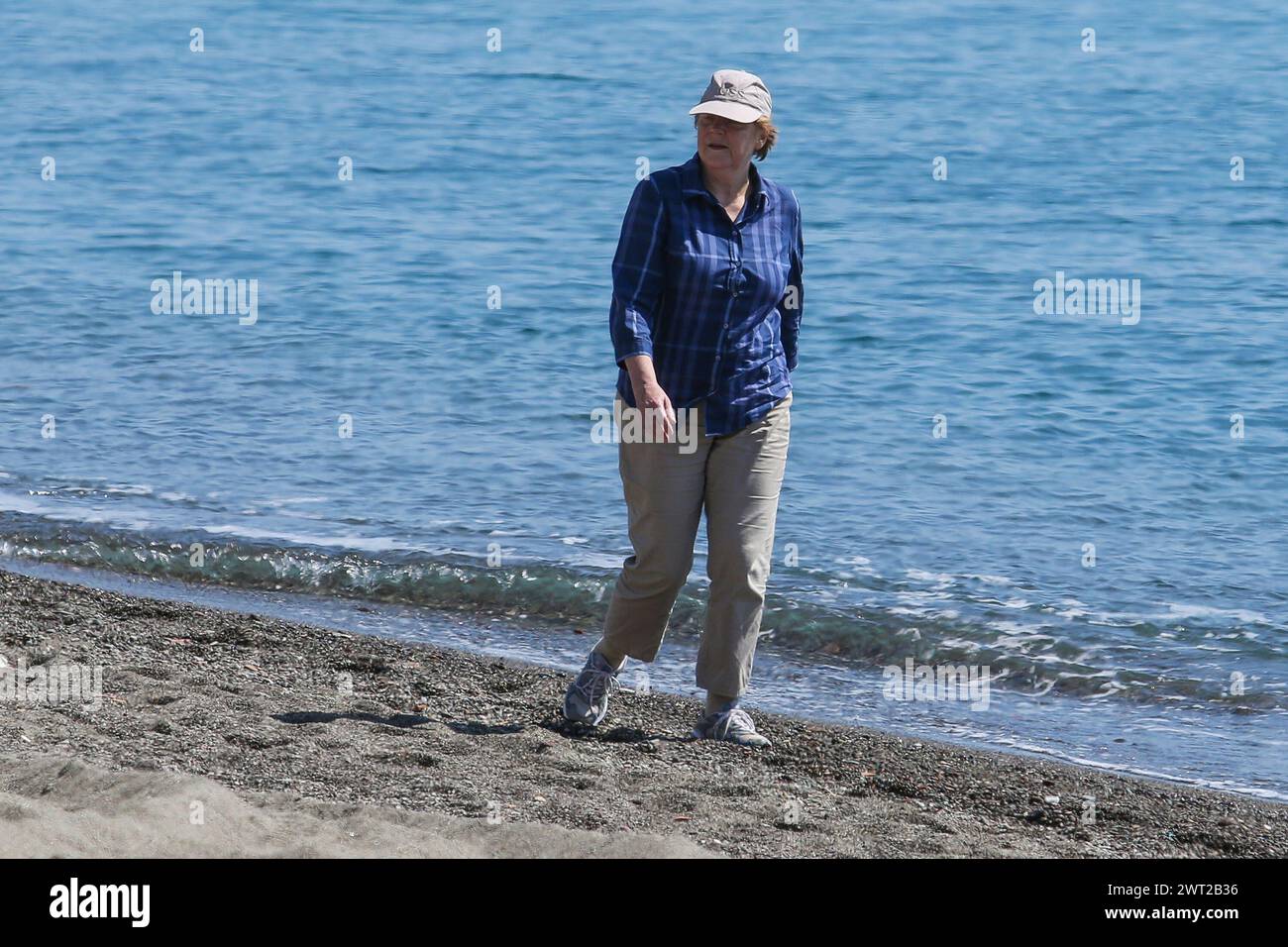 German Chancellor Angela Merkel, with her husband, take a walk to the ...
