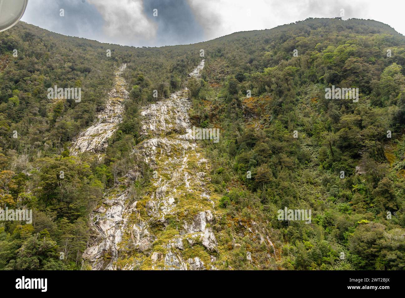 The aftermath of a tree avalanche is visible on a mountain side along ...