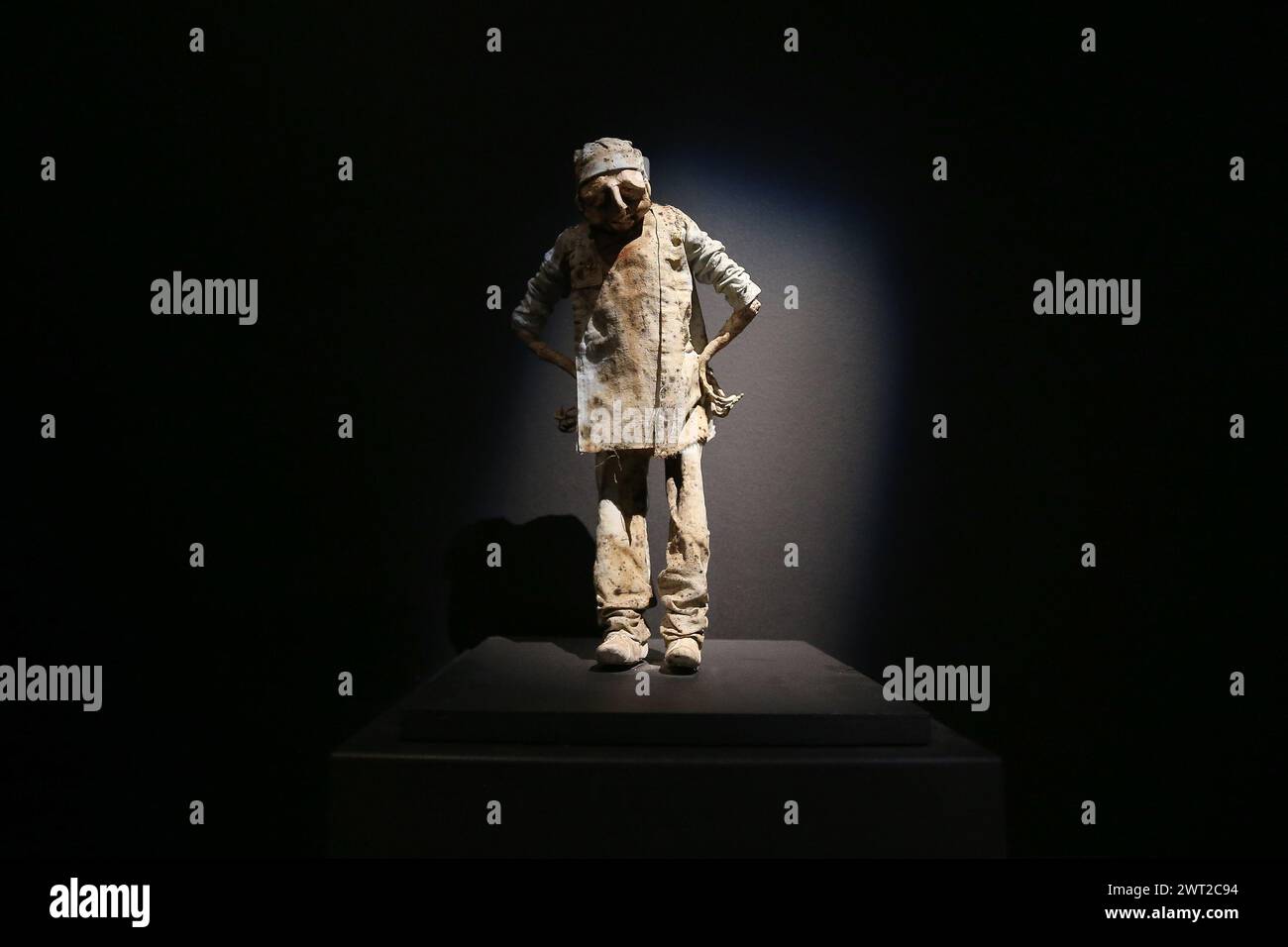 A small statue depicting a typical madman locked up in an asylum, in ...