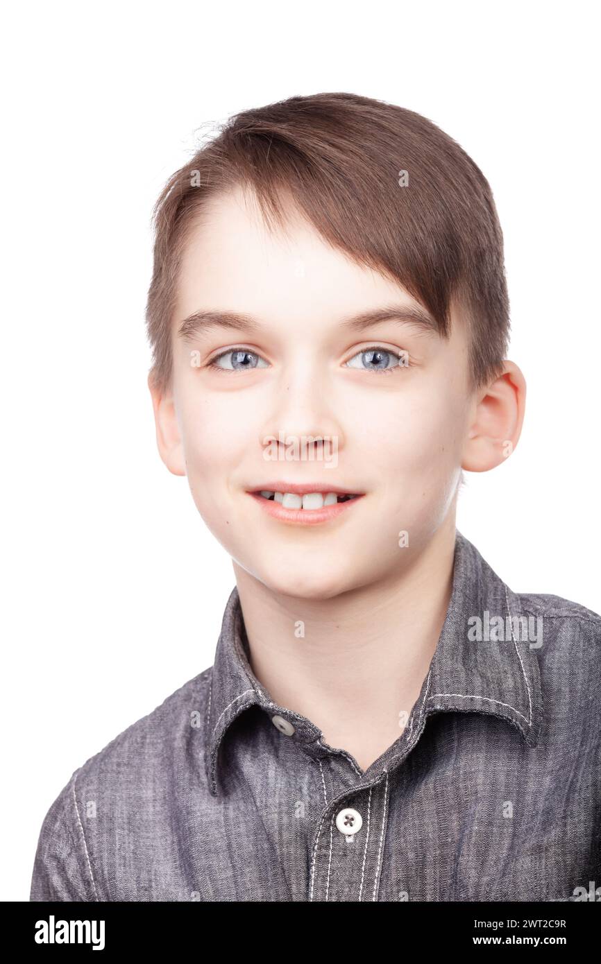 A portrait of cheerful and relaxed young boy with a subtle smile ...