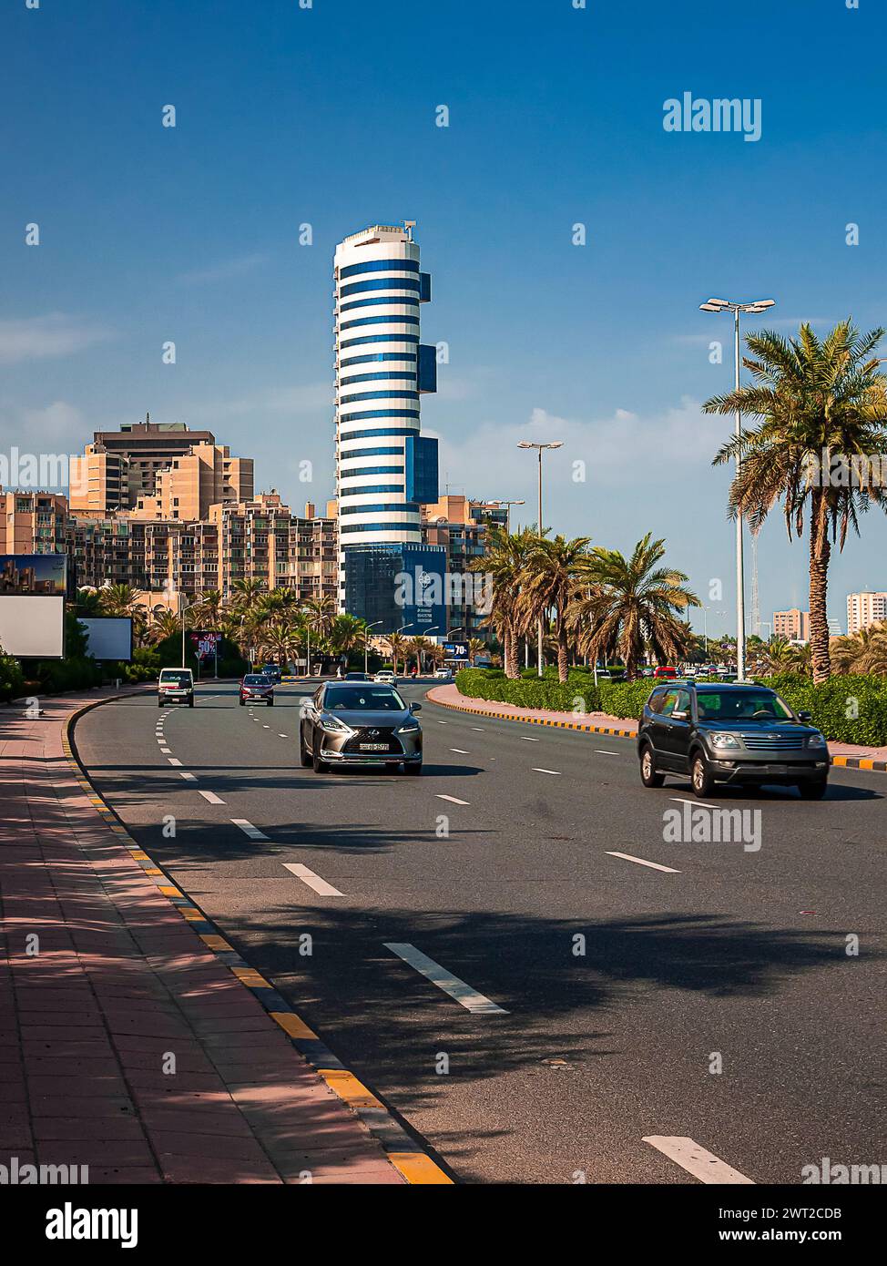 Cars travel along a highway along the coastal strip of Kuwait City ...