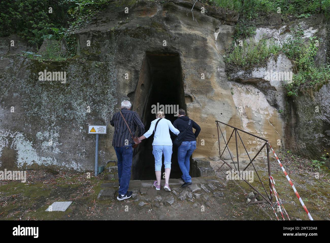 A tourist, visibly frightened, as she enters the cave of the Sibilla ...