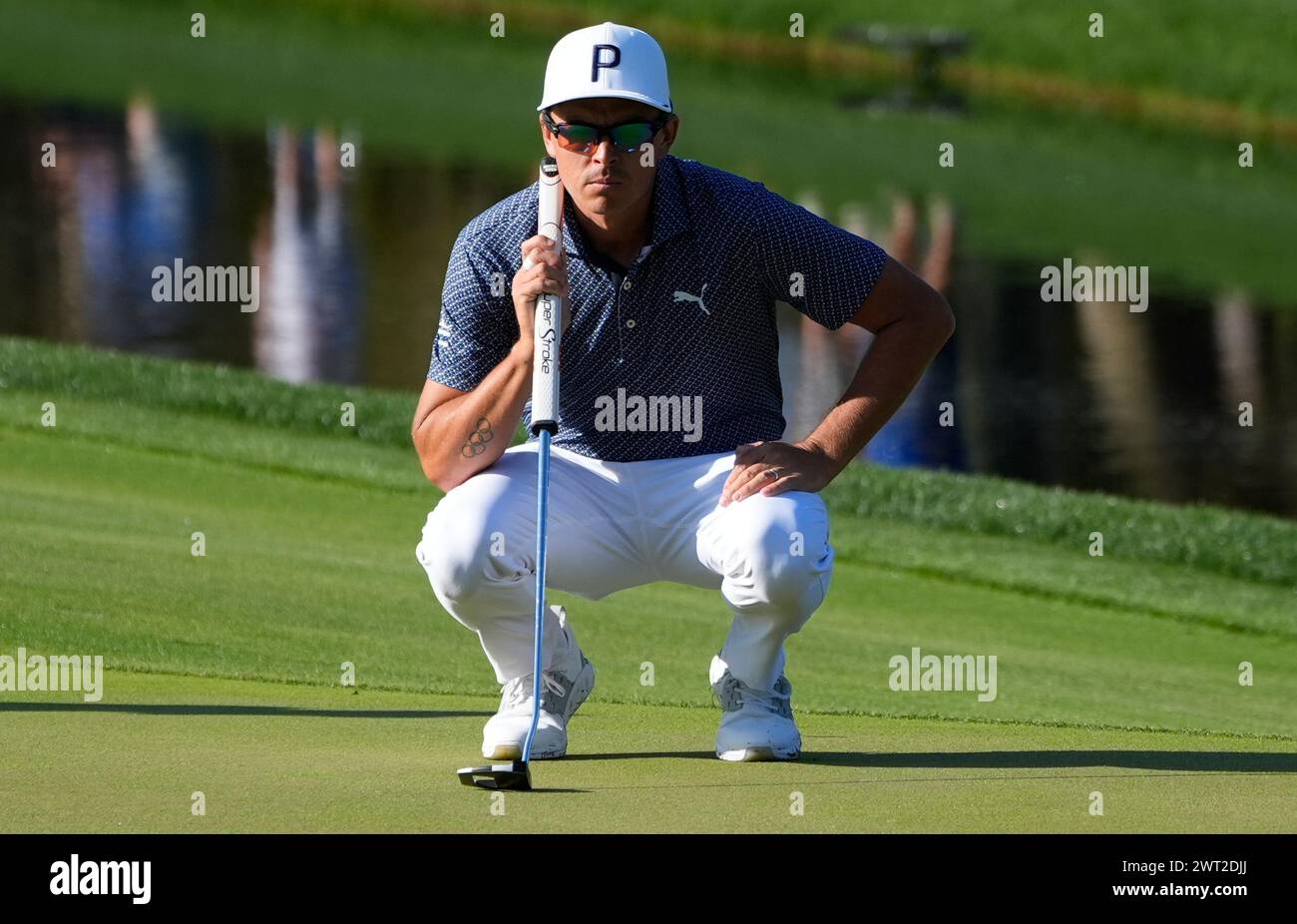 Rickie Fowlers lines up a putt on the 12th green during the second ...