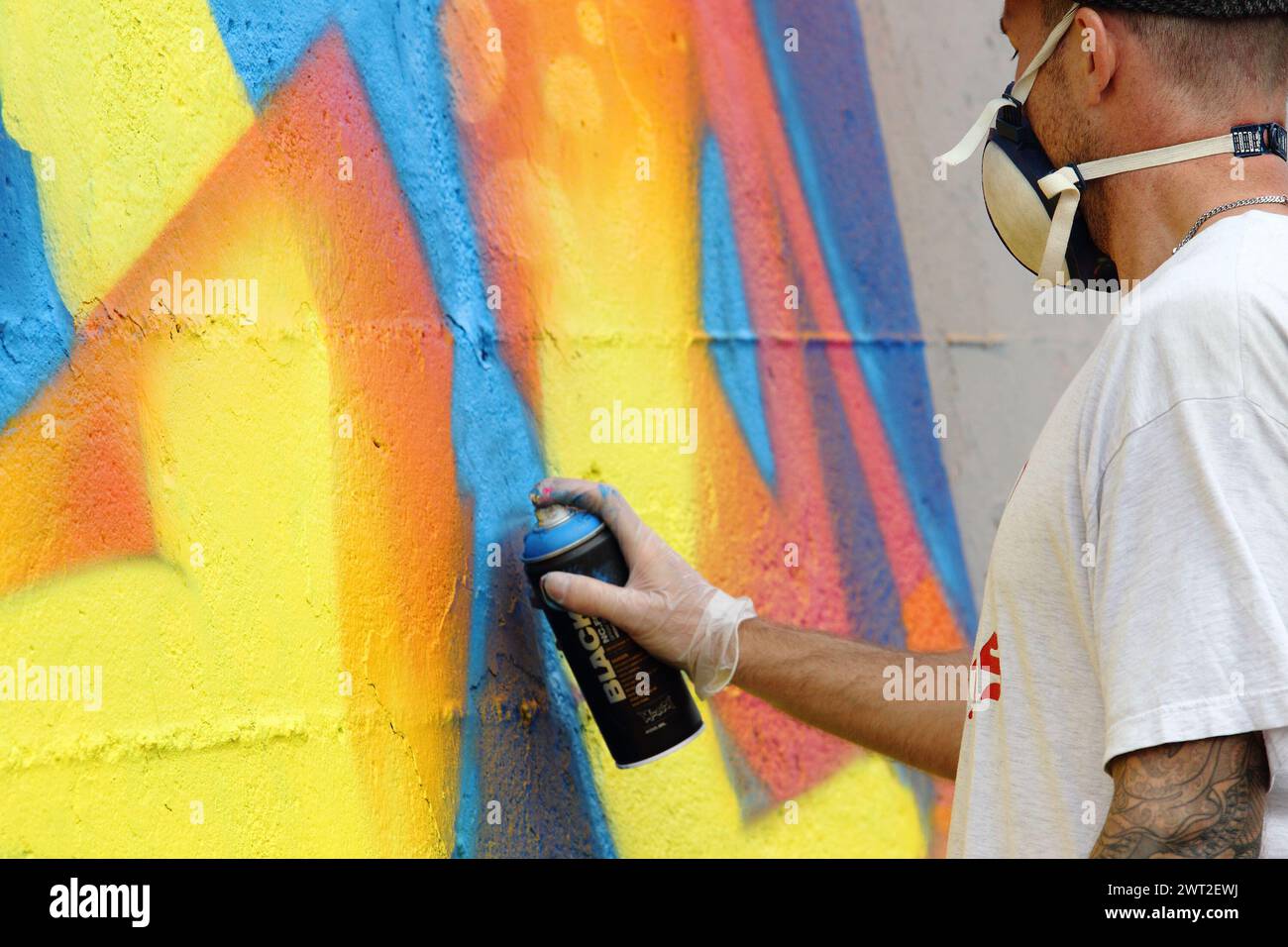 An artist while creating a mural during the Writers Reunion "Just ...