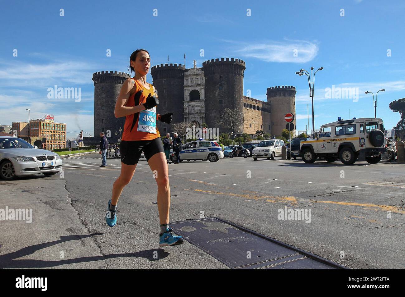 A runner during the Naples Marathon, behind the New Castle aka Maschio ...