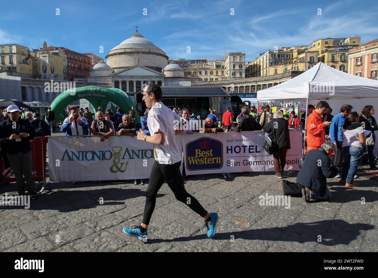 A runner during the Naples Marathon, behind Plebiscito square Stock ...
