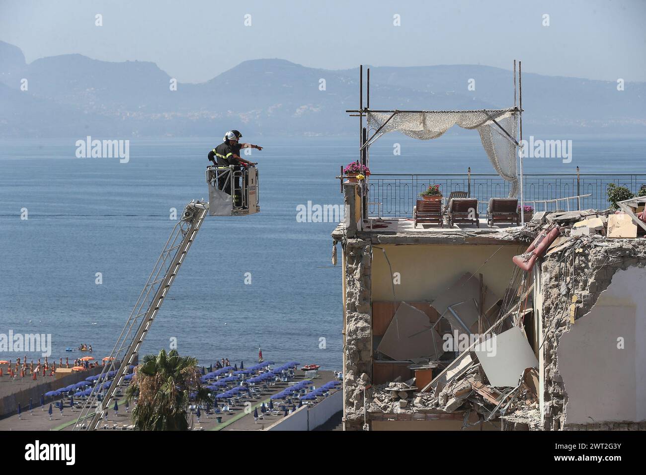 Rescue workers on the rubble of the collapsed building in Torre ...