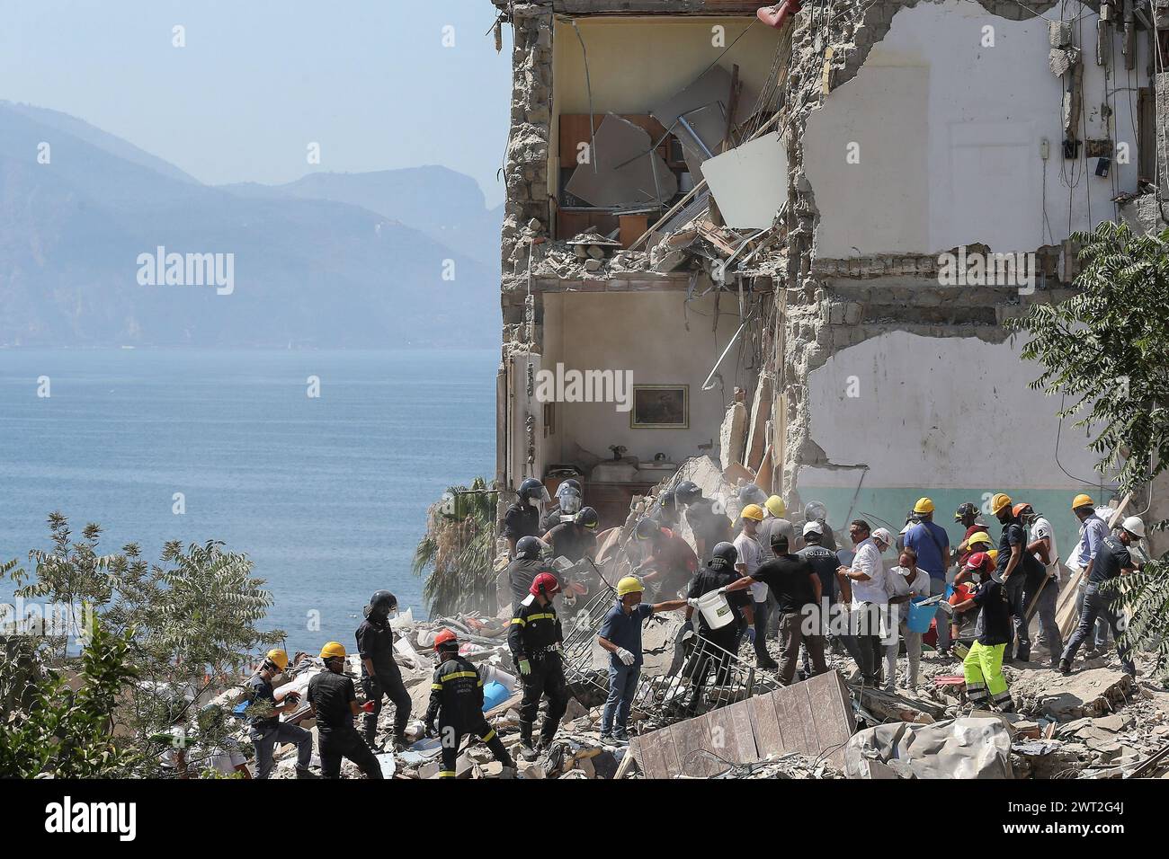 Rescue workers on the rubble of the collapsed building in Torre ...