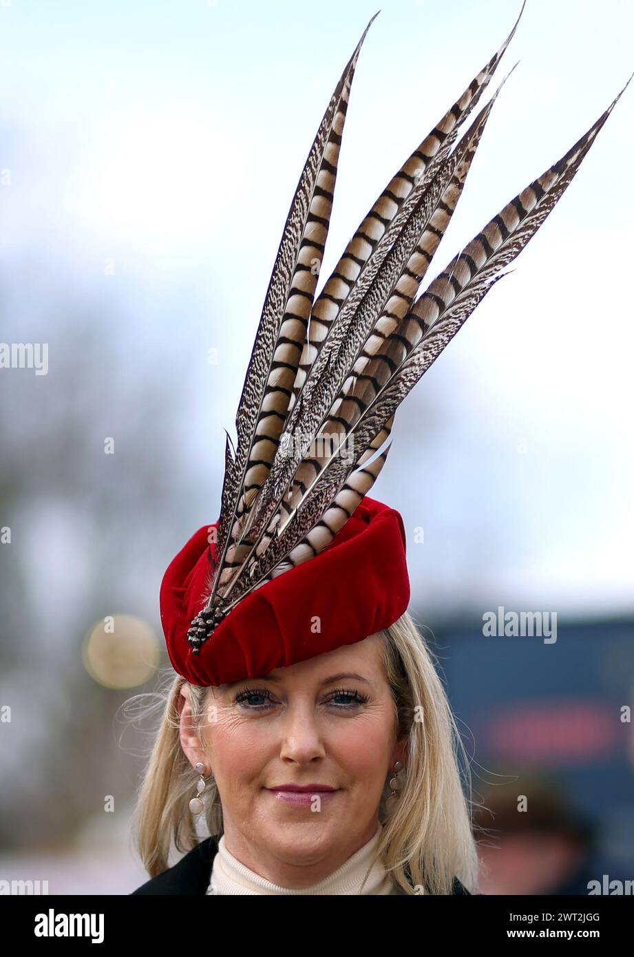 A racegoer in a hat on day four of the 2024 Cheltenham Festival at ...