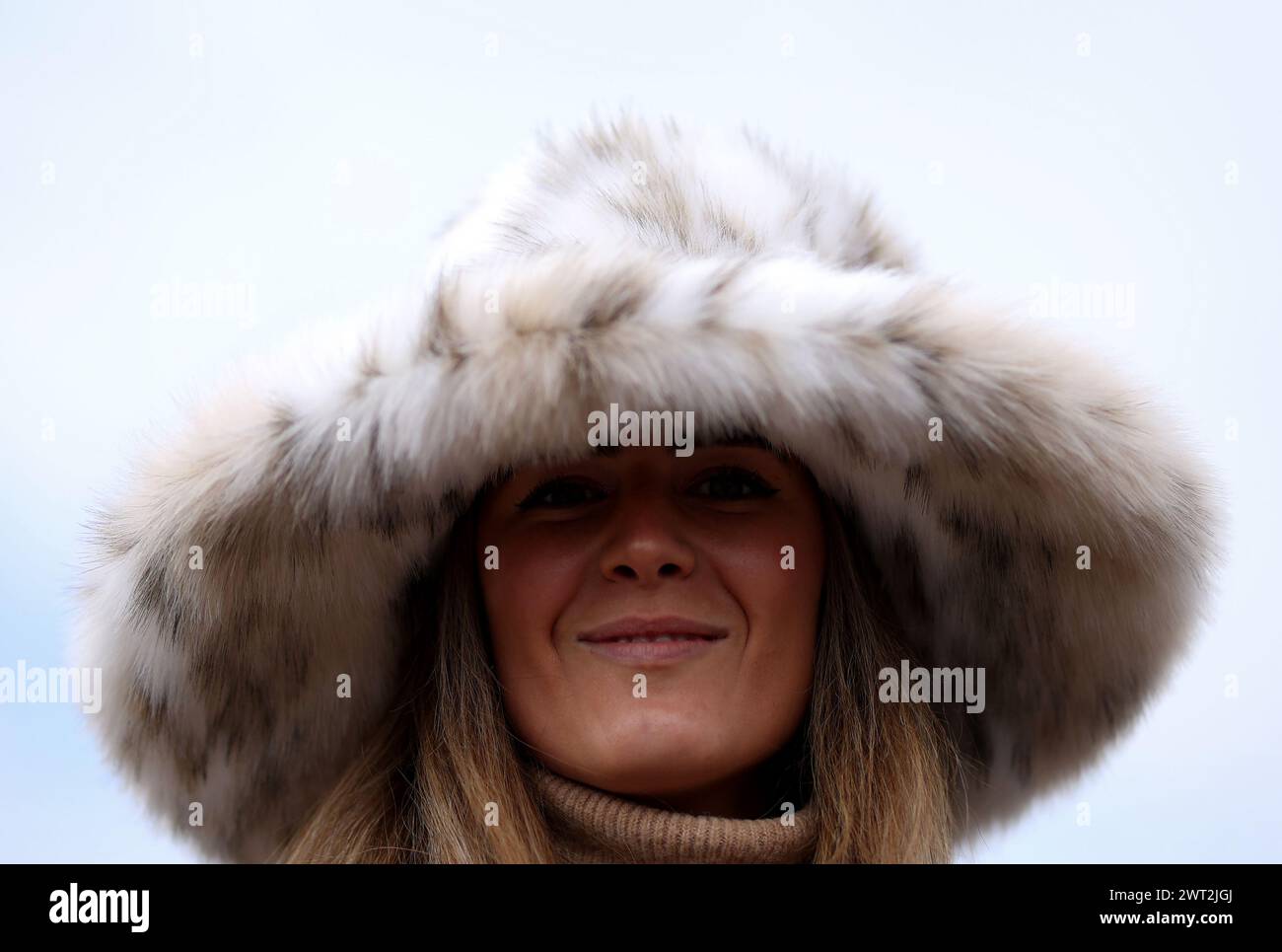 A racegoer in a hat on day four of the 2024 Cheltenham Festival at ...