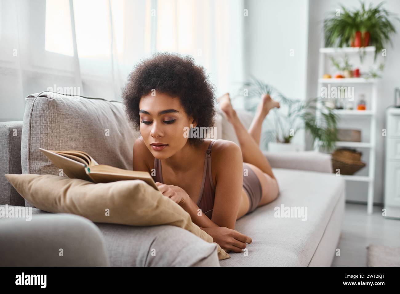 Concentrated And Curly Haired African American Woman Reading A Book In