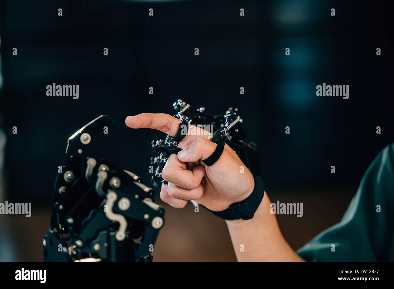 Asian teenage boy explores technology testing a robot hand and arm for ...