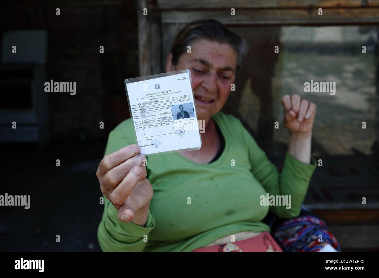 A gypsy woman shows her identification document during the eviction of ...