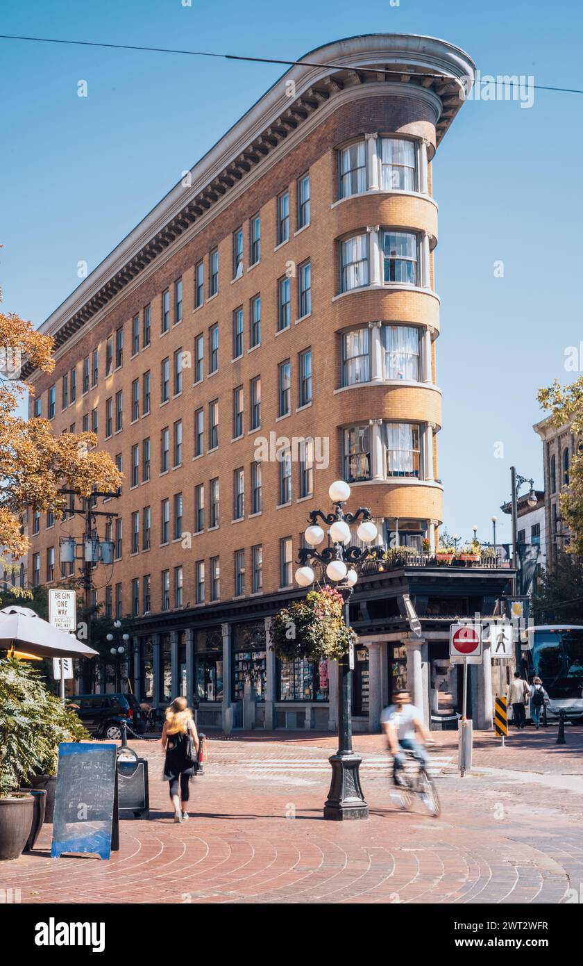 Pedestrians move in front of a distinctive, curved historic building on ...