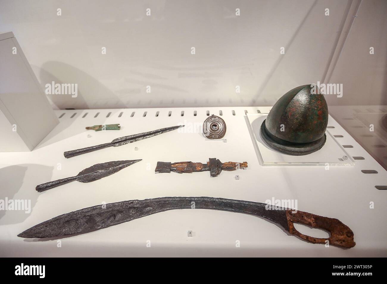 Etruscan helmet and a sword, with spears, exhibited in Pompeii during ...