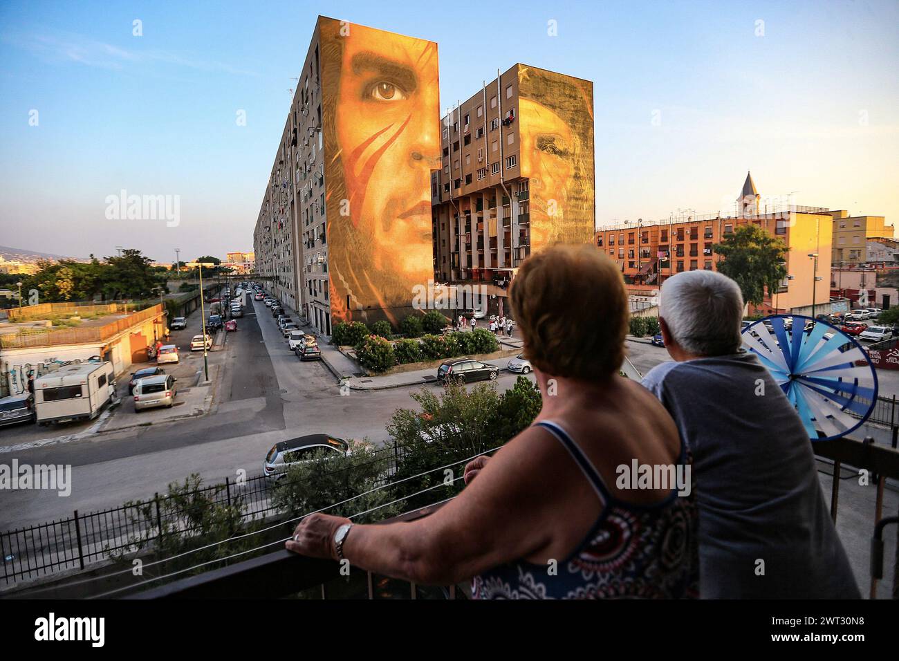 A man and a woman, from our house, look the giant murals, depicting the ...