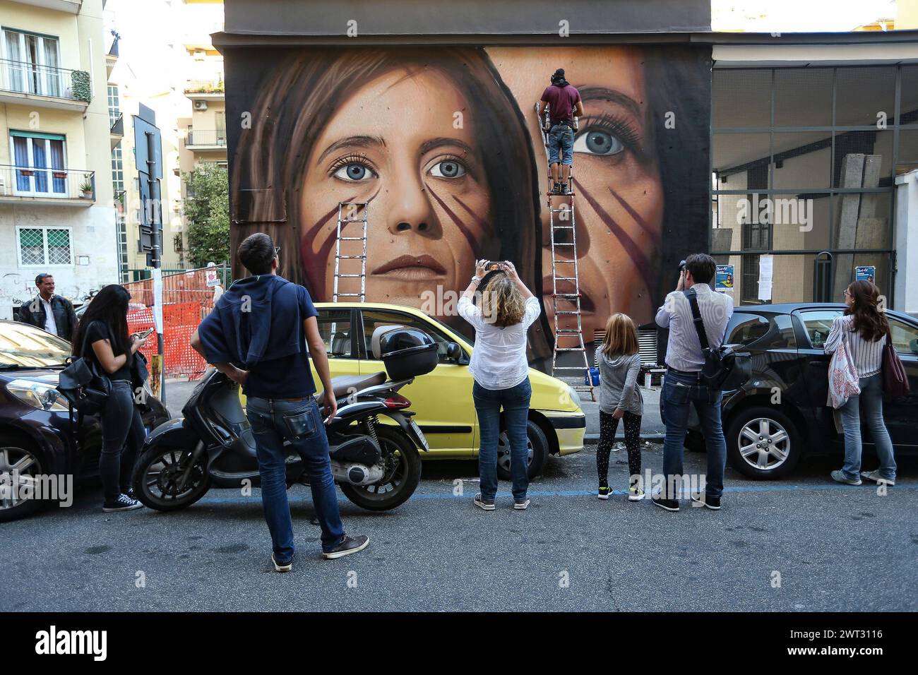 The street artist Jorit Agoch at work on a giant murales of Ilaria ...