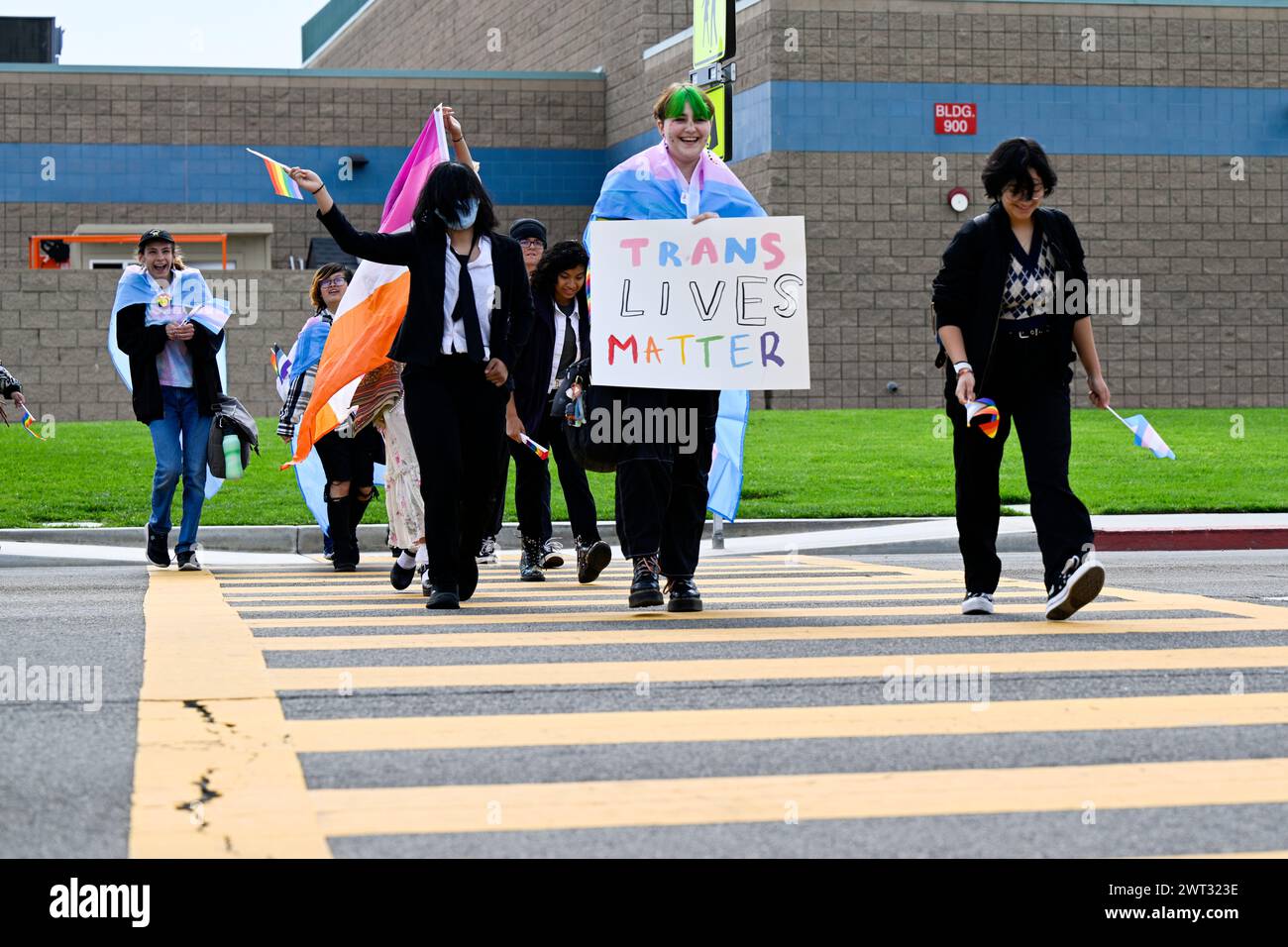 FILE - Students carrying pride flags and transgender flags leave Great ...