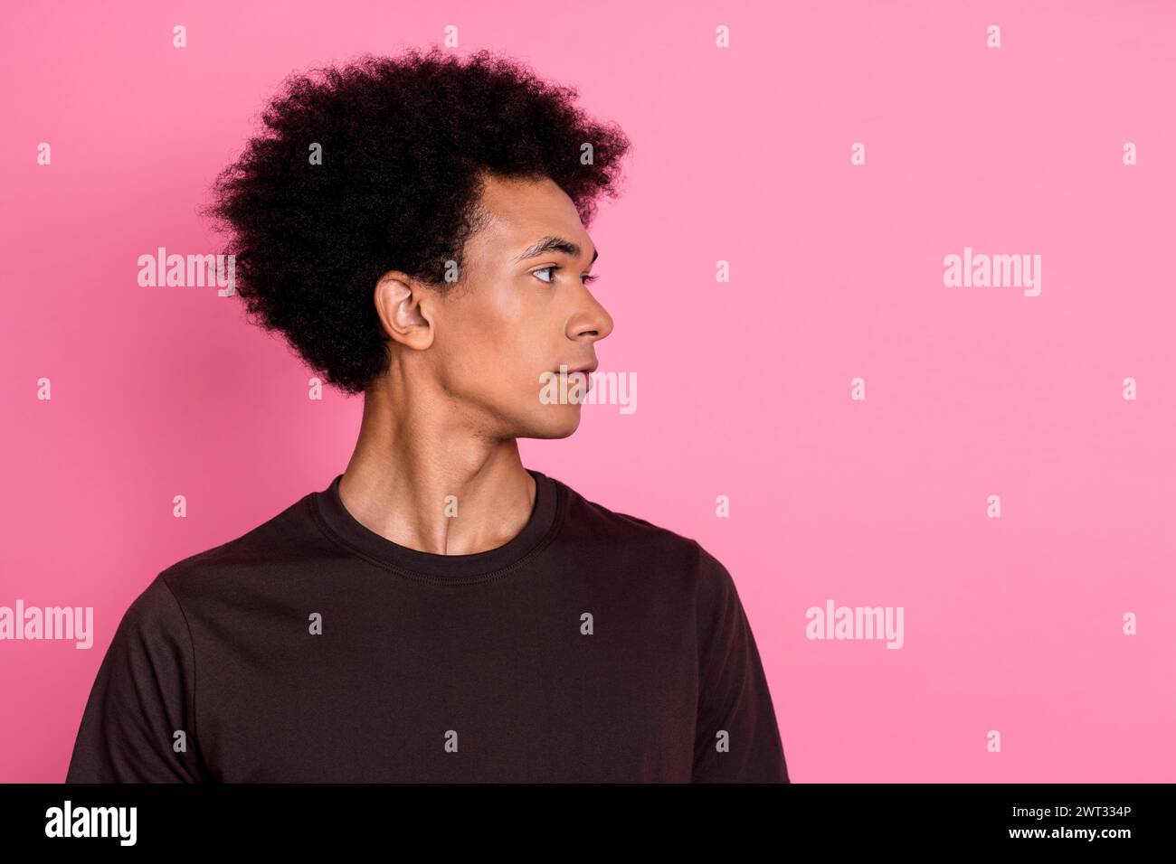 Side photo of young curly chevelure hair guy in brown t shirt looking ...