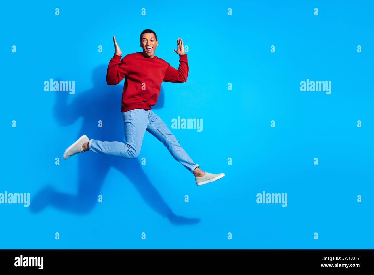 Full body profile photo of astonished sporty person raise hands jump ...