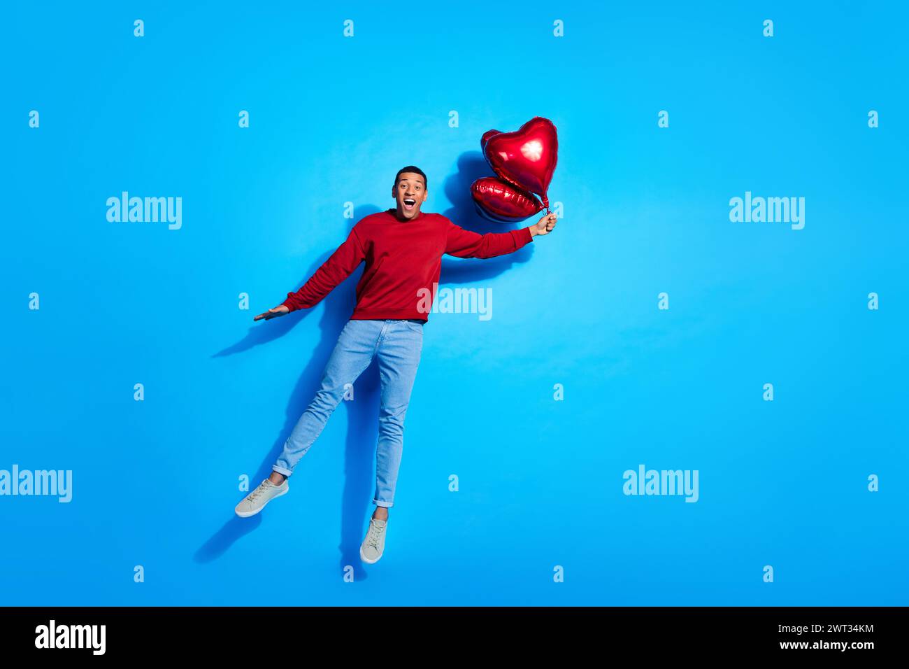 Full length photo of impressed overjoyed person arm hold heart shape ...