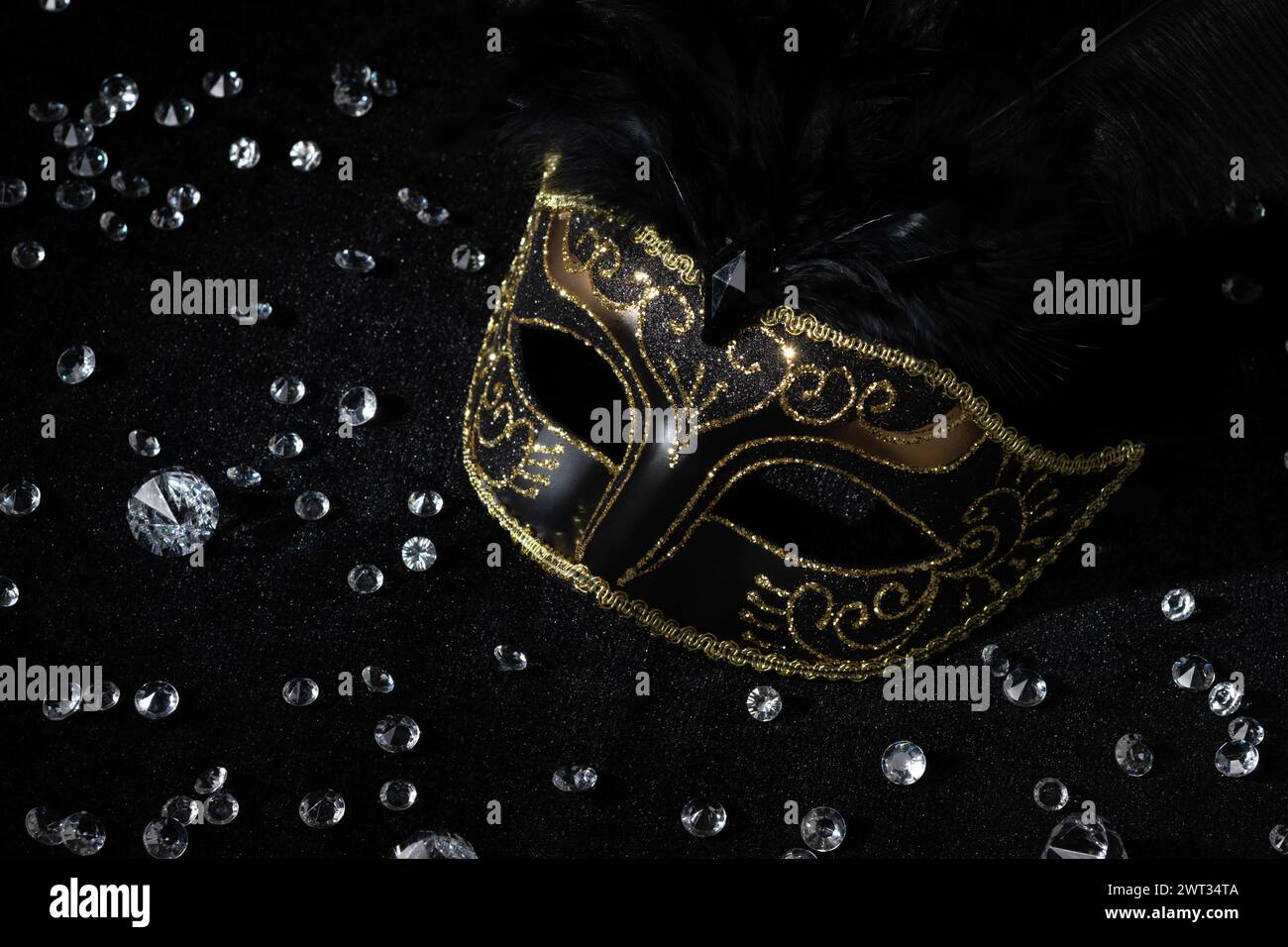 Close-up view of Carnival gold mask with diamonds on black background ...