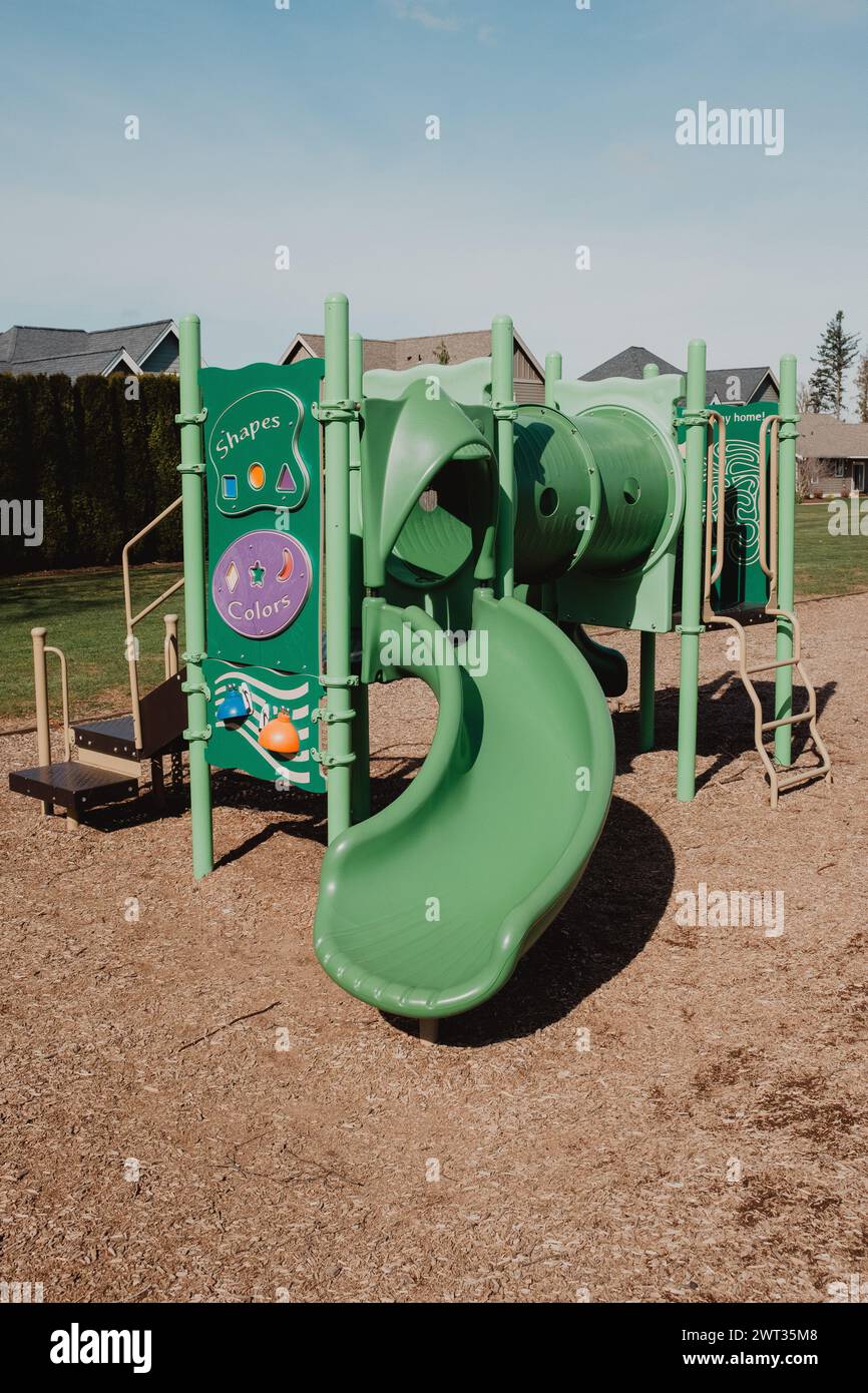 Small play ground with swing set and slide Stock Photo - Alamy