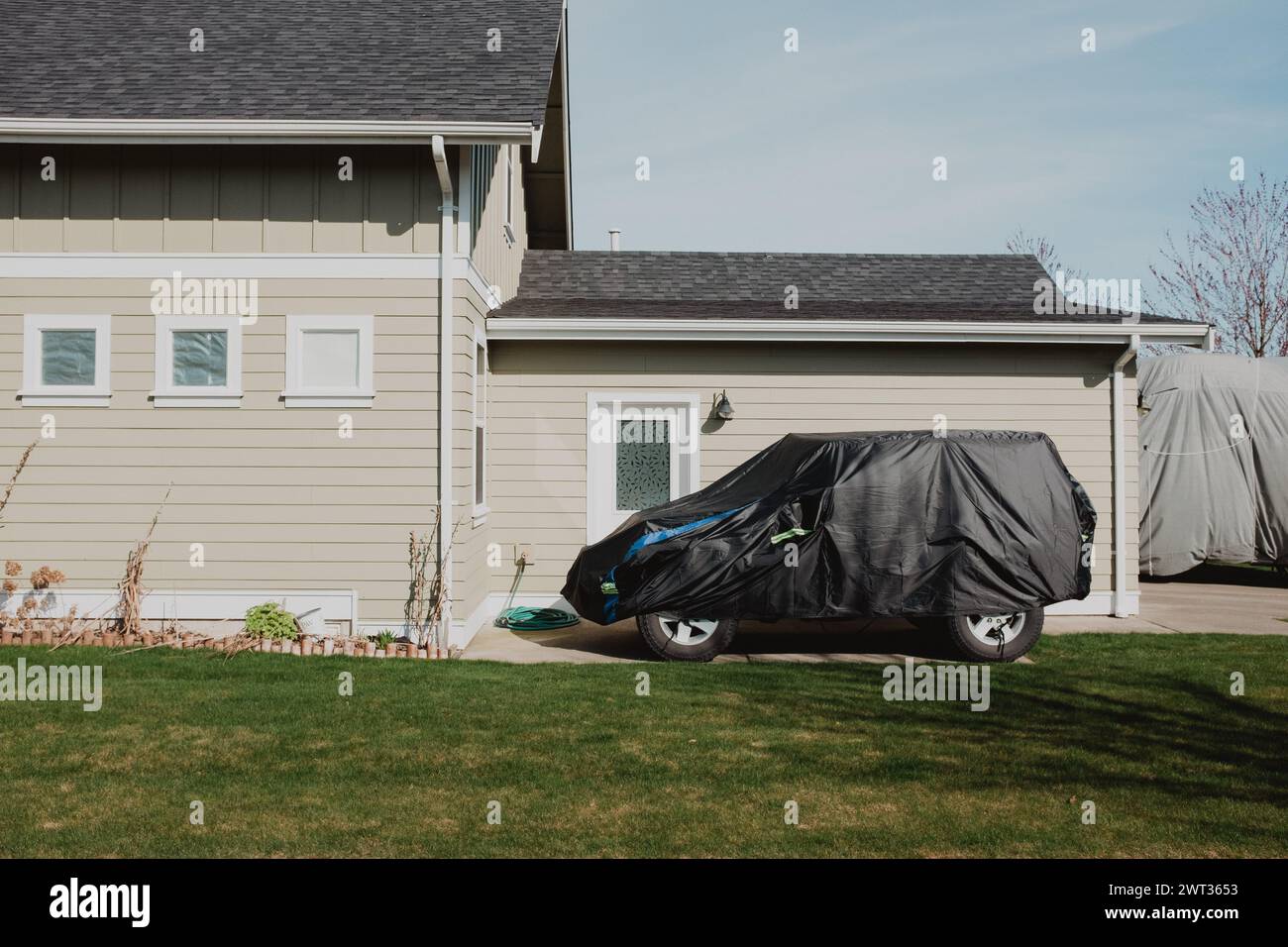 covered car by house Stock Photo - Alamy