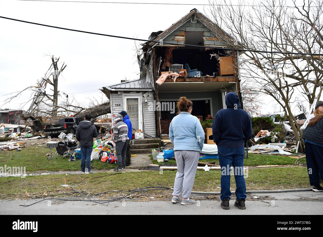 Brittany Oakley, center, looks at what is left of her home following ...