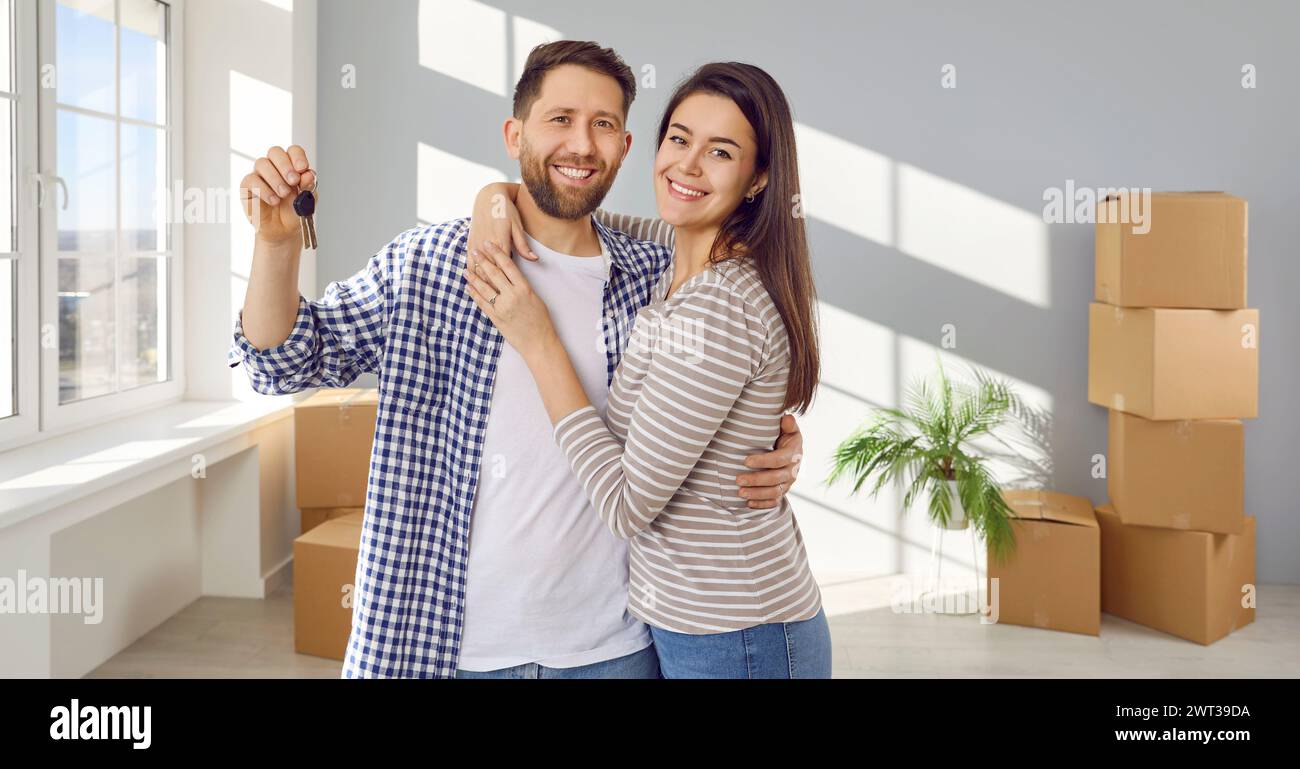Married smiling couple buying their new home. Happy family couple in ...