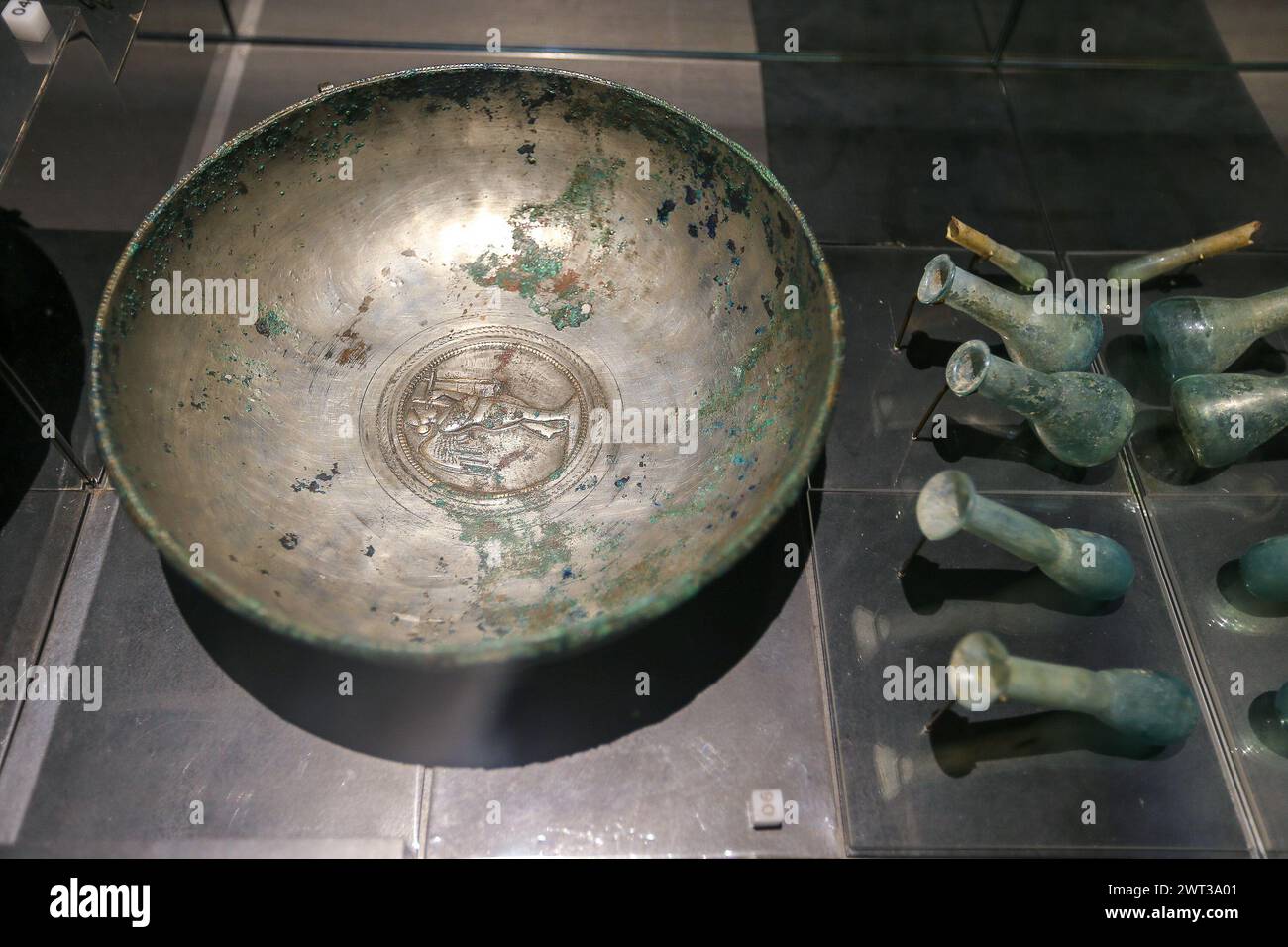 Ancient pompeian objects, including amphorae and a silver tray, inside ...