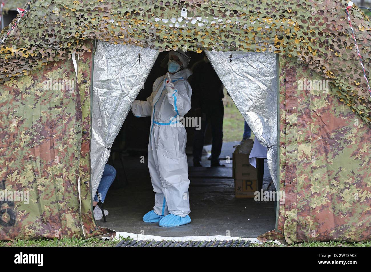 A doctor, dressed in overall and mask to protect himself, in the ...