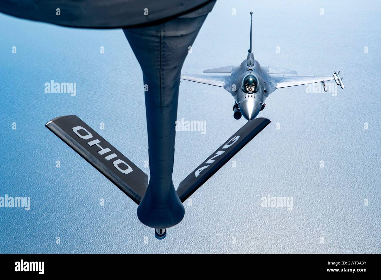 A KC-135 Stratotanker with the 121st Air Refueling Wing refuels an F-16 ...