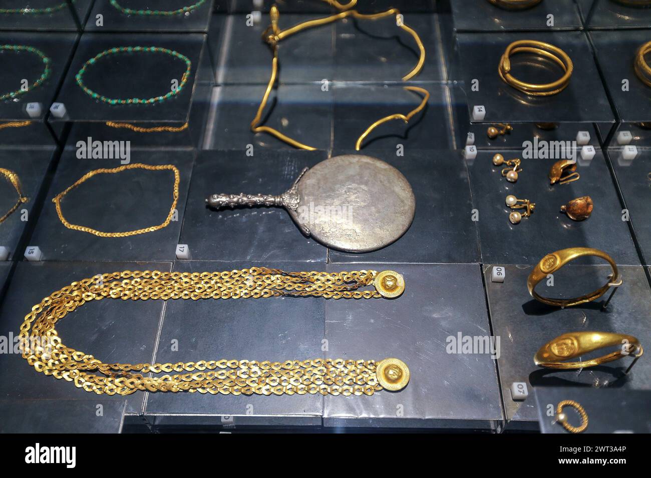 Ancient pompeian objects, including a gold necklace, gold rings and a ...
