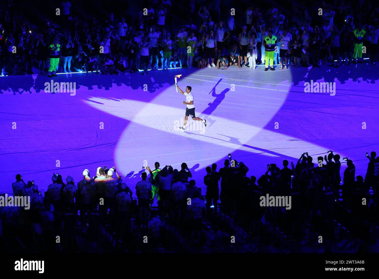 An athlete carries the torch games during the opening ceremony of the ...