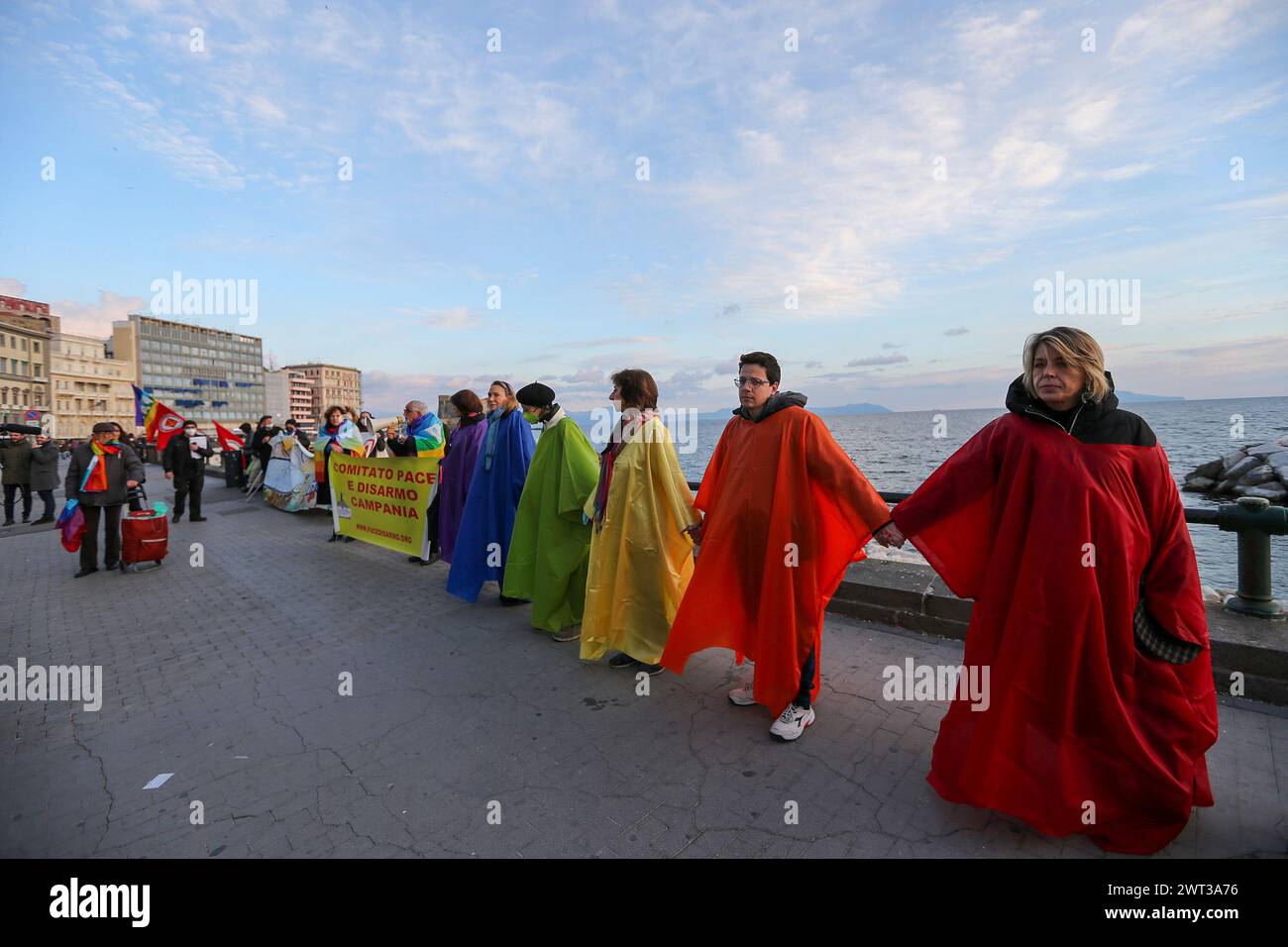 People wrapped in flags with the individual colors of the rainbow, on ...