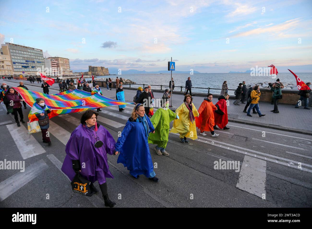 People, with a giant flag in the colors of the rainbow, on the Naples ...