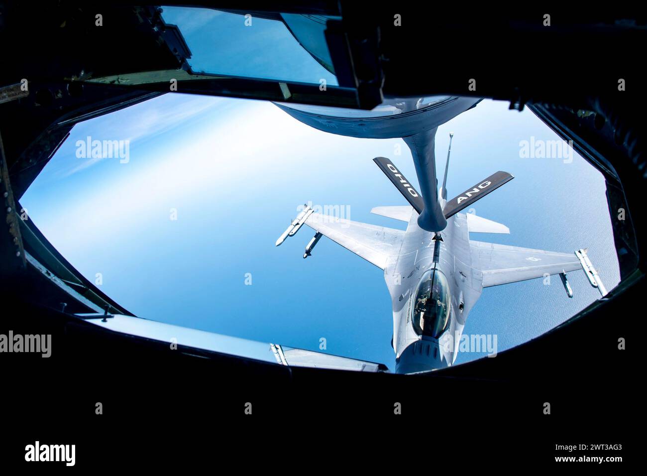 A KC-135 Stratotanker with the 121st Air Refueling Wing refuels an F-16 ...