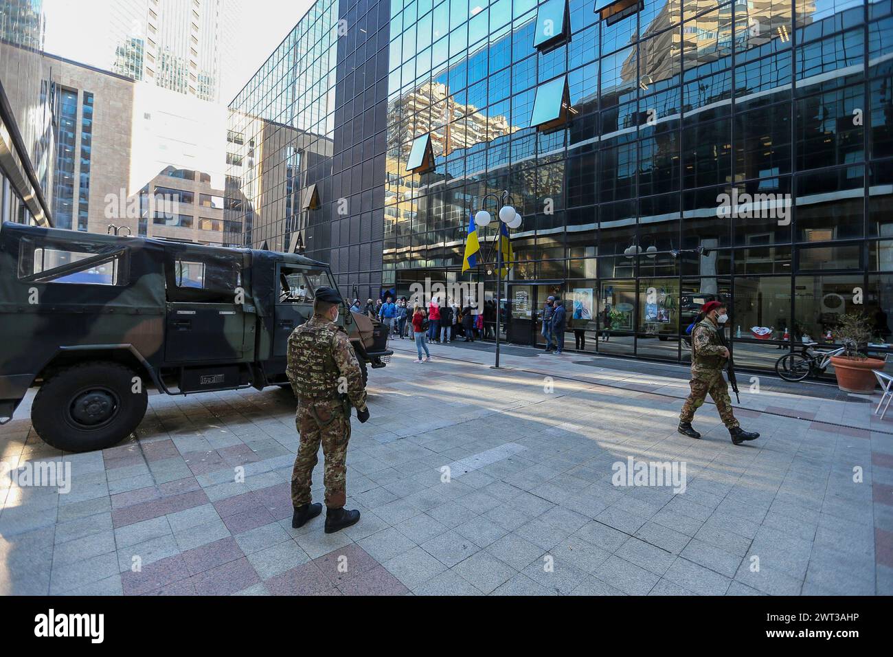 Italian soldiers on guard in front of the line of Ukrainian refugees ...