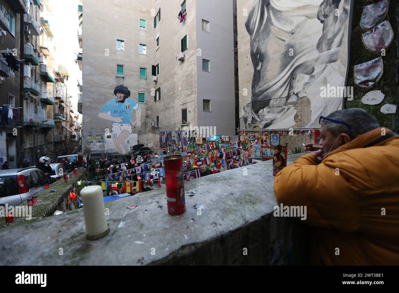 A man looks at the Diego Armando Maradona's giant mural in the Spanish ...