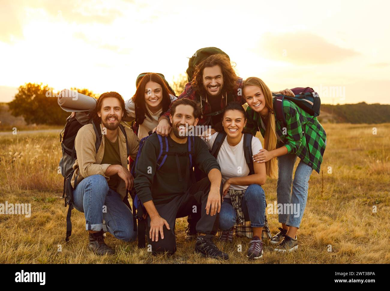 Group of friends tourists trekking with backpacks during a walking tour ...