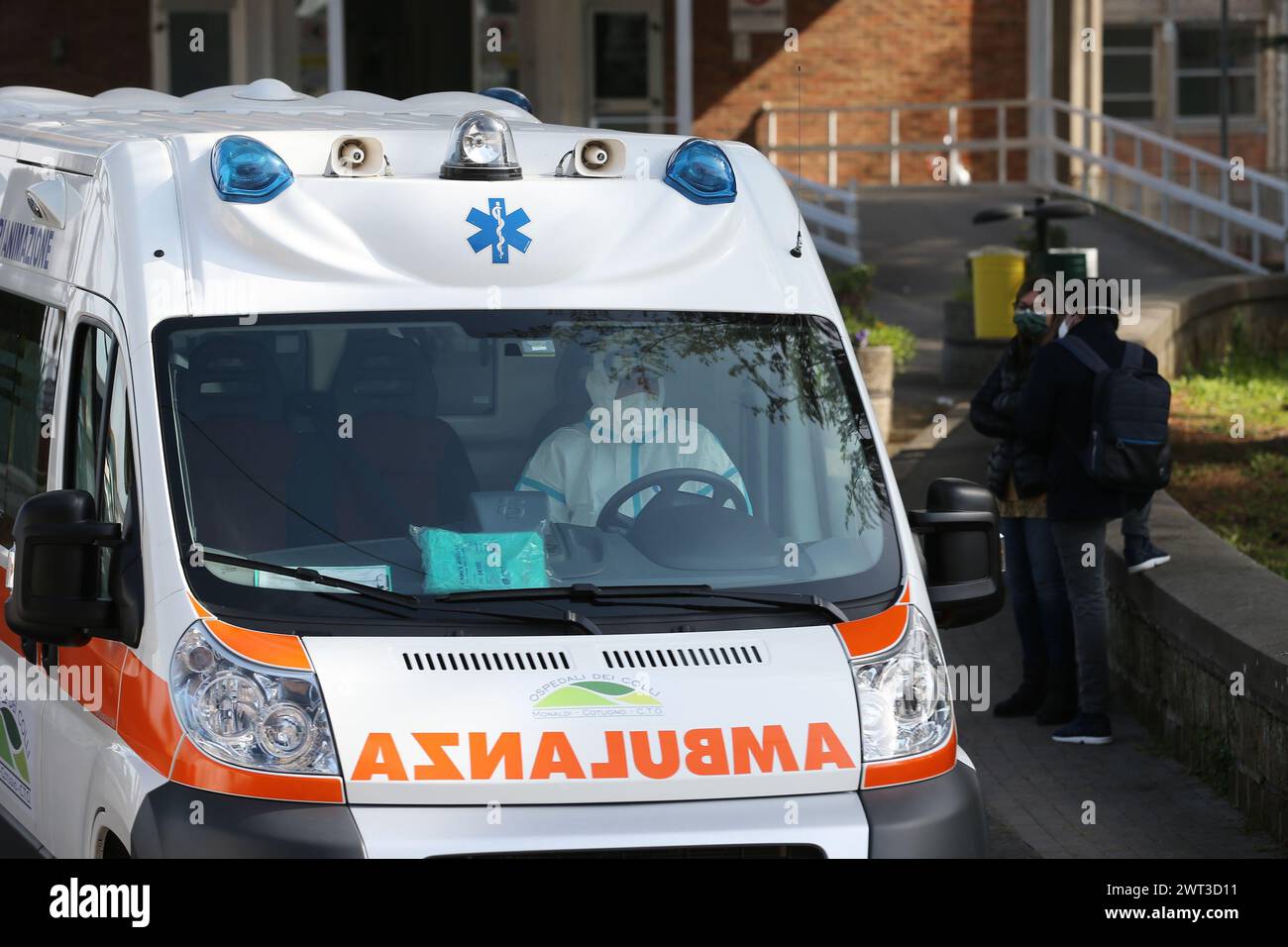 An ambulance with a masked driver to protect against the COVID-19 ...