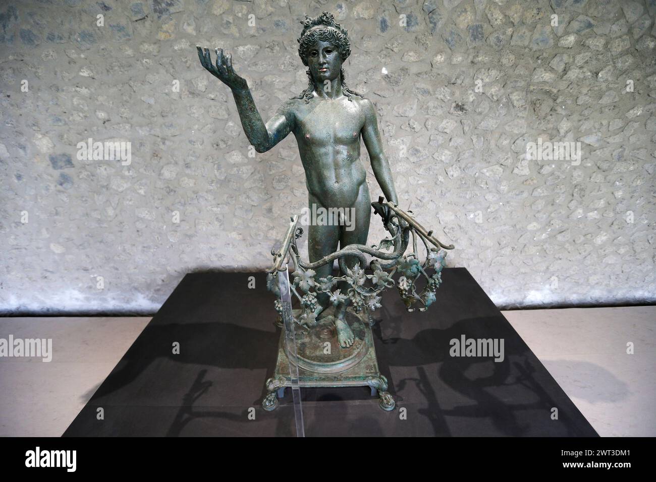 A bronze sculpture representing an ephebe carries oil lamps, inside the ...