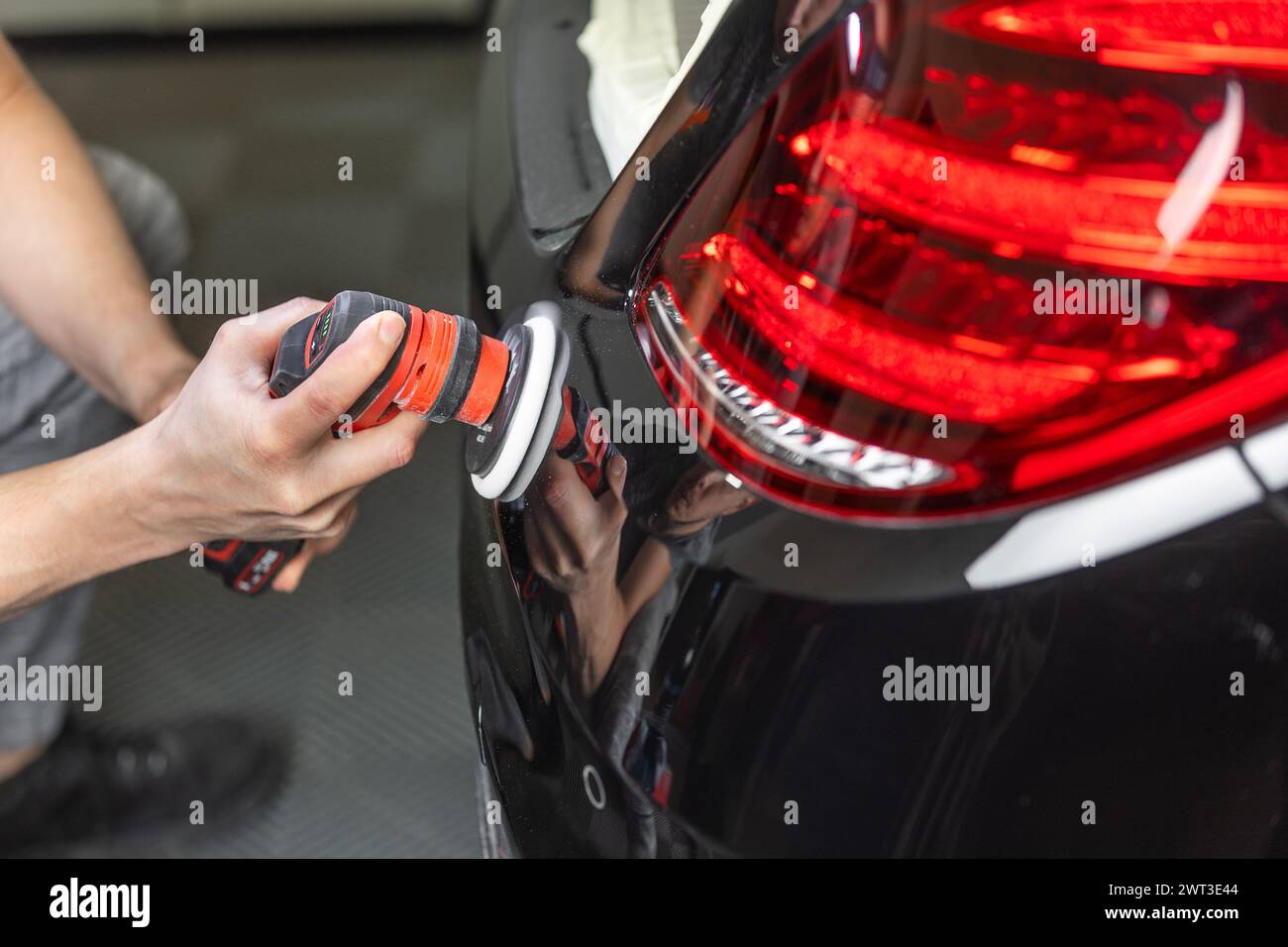 Close up of man hand removing a scratches from the bottom of car by an ...