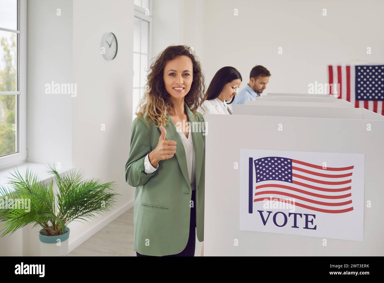 Happy smiling american voter woman looking at camera and showing thumb ...