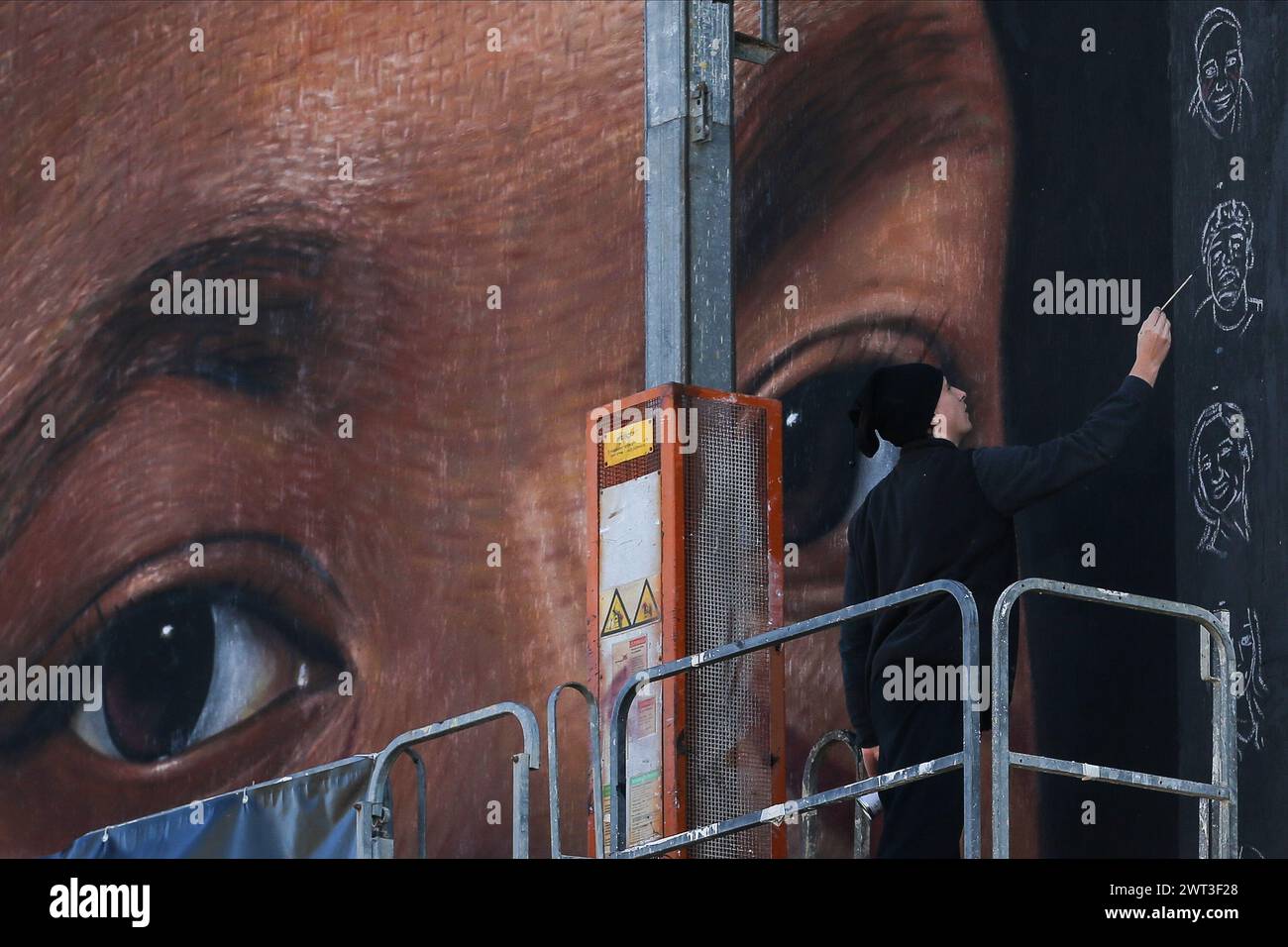 The street artist Jorit Agoch while working on the Martin Luther King ...