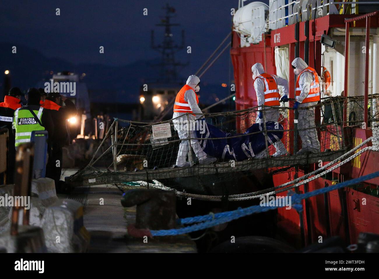 The corpse of a migrant, who died at sea during a shipwreck, is carried ...