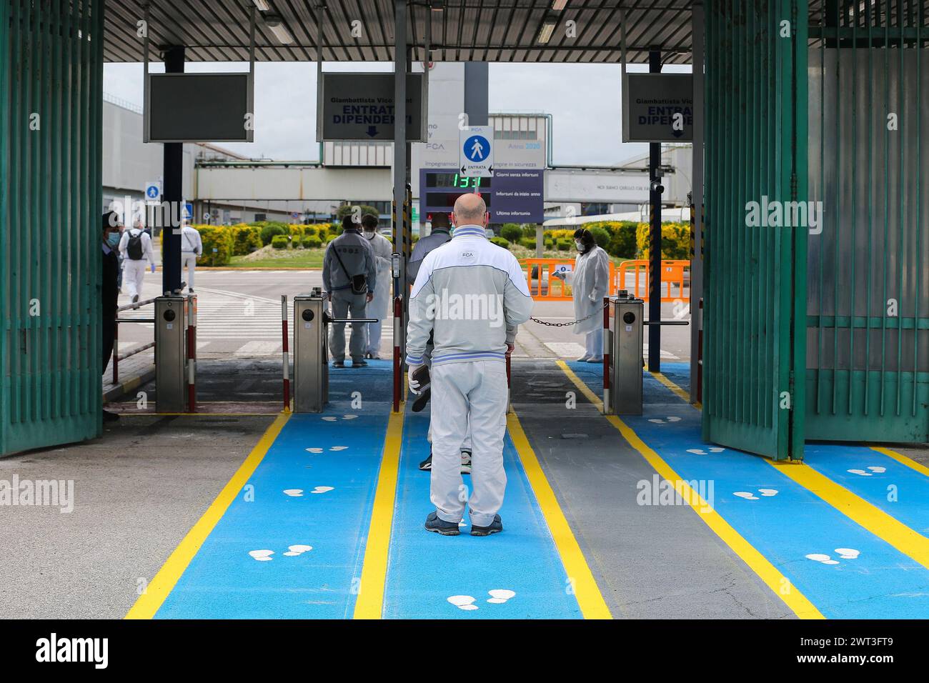 Workers, upon arrival at the just reopened Gian Battista Vico Plant of ...