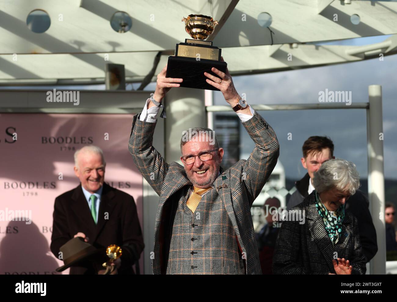Greg Turley, husband of owner Audrey Turley lifts the trophy after ...