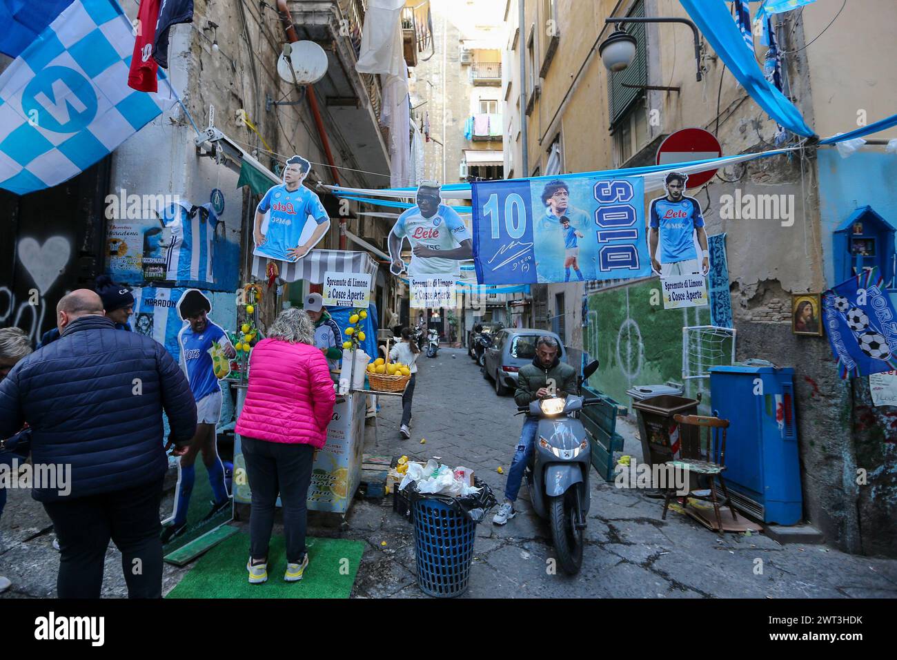 An alley in the Spanish quarters of the city of Naples, decorated by ...